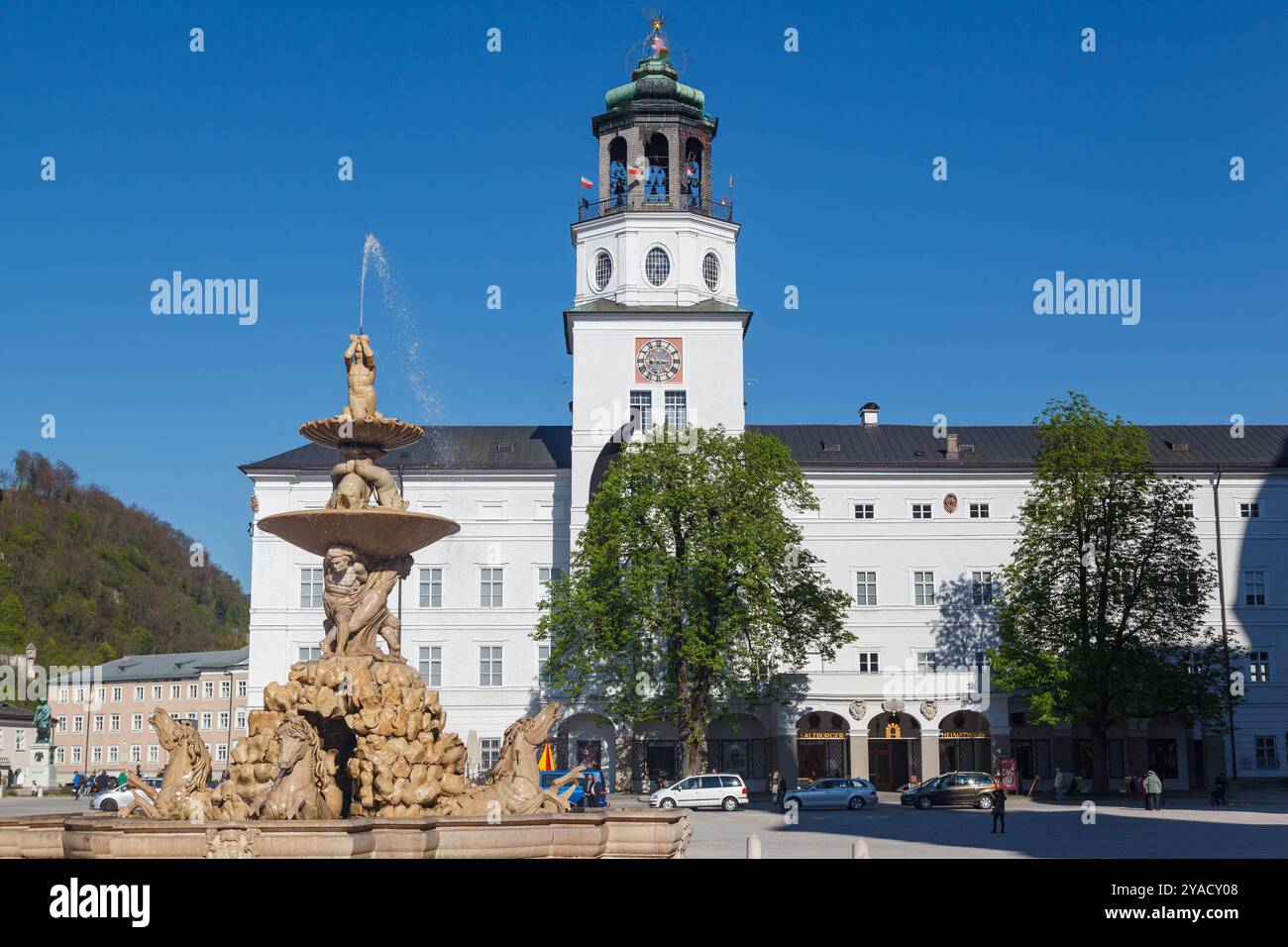 The Fountain and Salzburg Museum with its clock tower at Residentzplatz ...