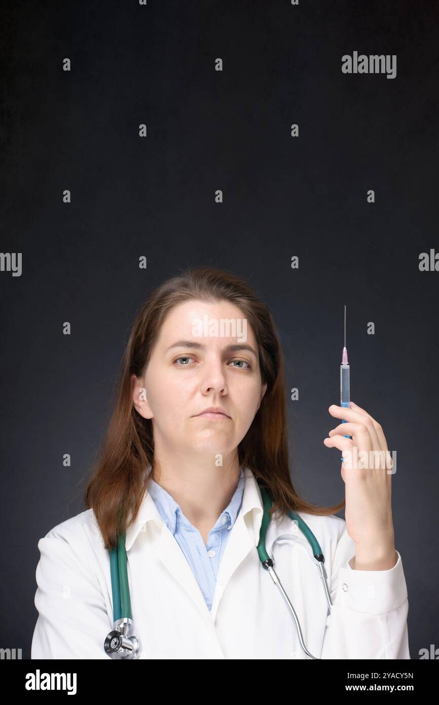 Portrait of a female doctor with syringe Stock Photo - Alamy