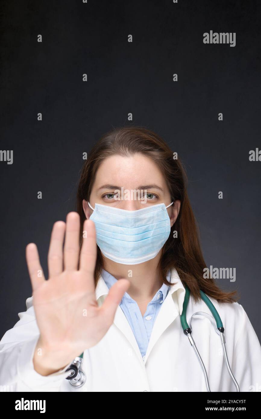 Female doctor showing stop sign Stock Photo - Alamy