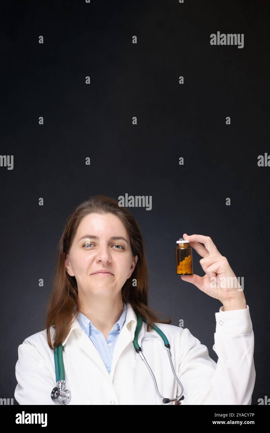 Young doctor holding pill container hi-res stock photography and images ...