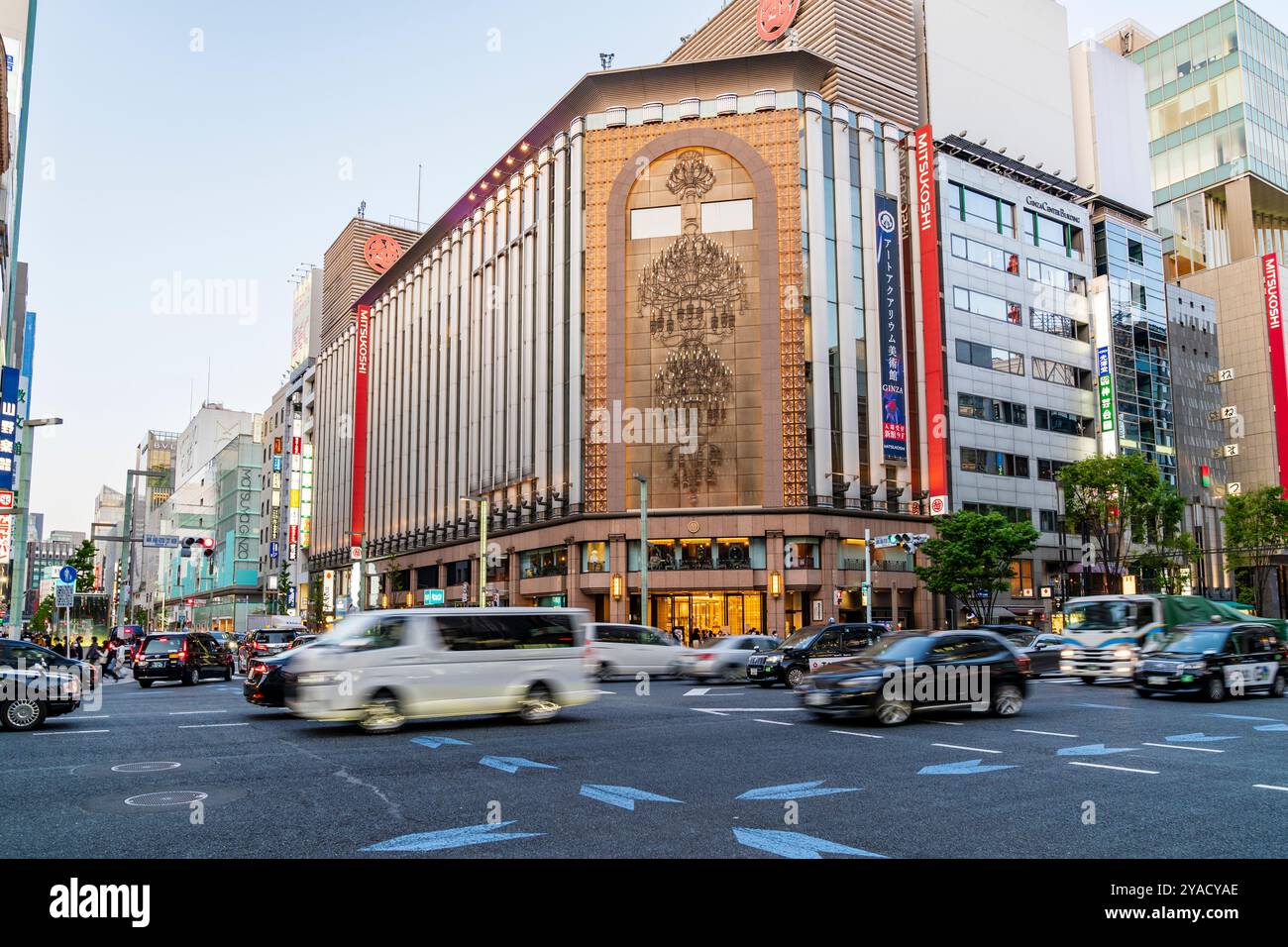 Tokyo, the Ginza 4 interchange with traffic going past and flagship ...