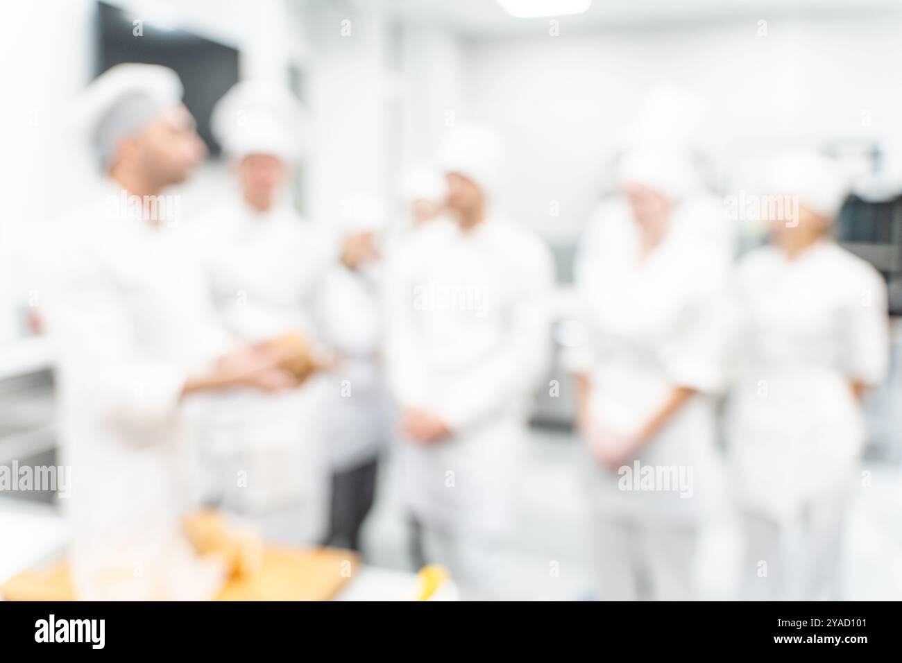Blurred background: a cooking teacher or a chef conducts a master class ...