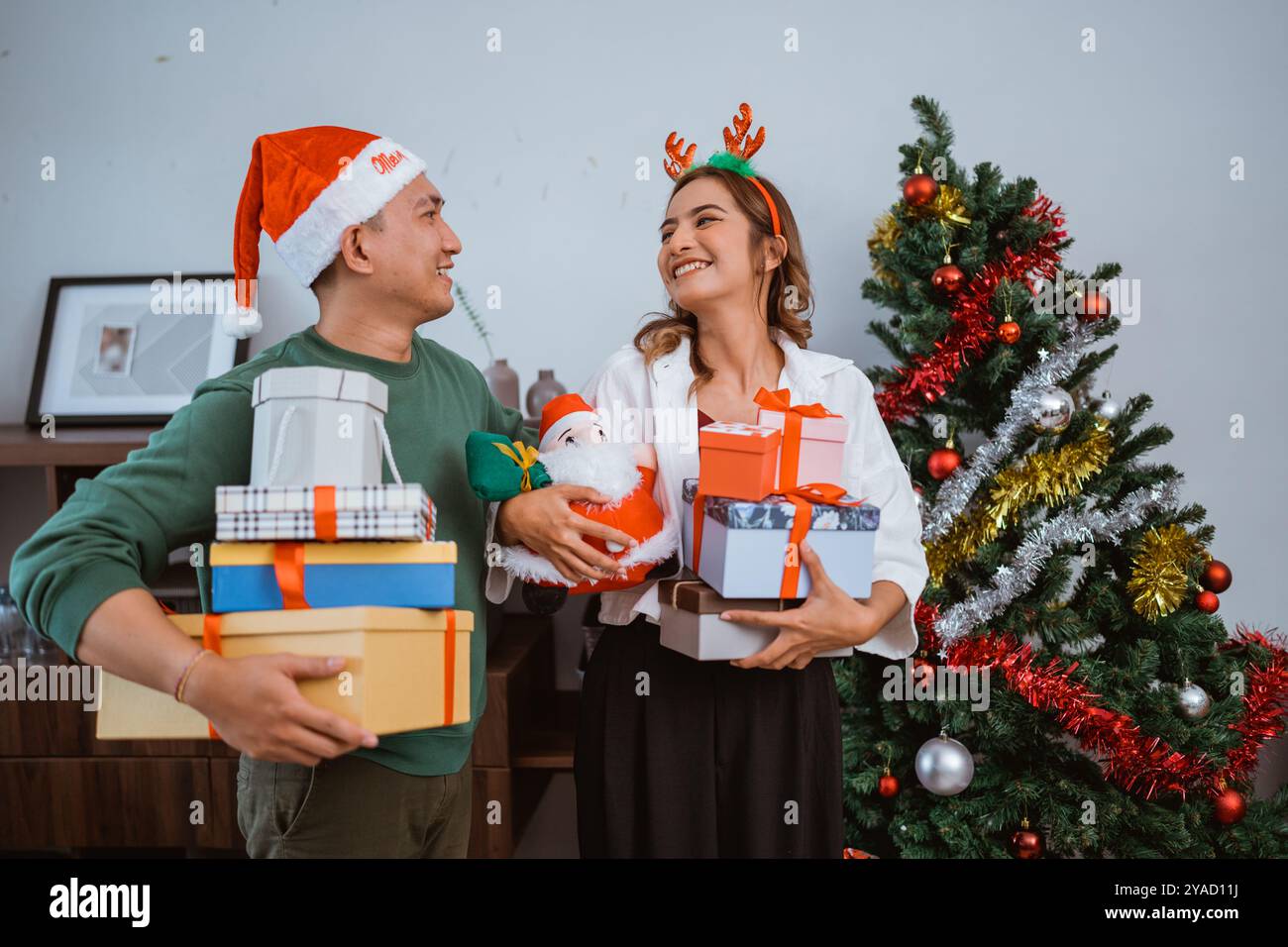 Friends joyfully celebrating christmas together hi-res stock ...