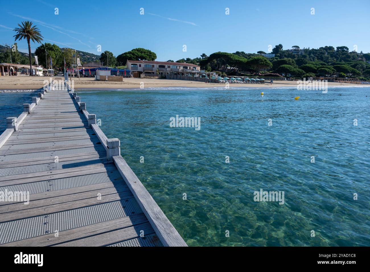 Morning view on crystal clear blue water and pier of Plage du ...
