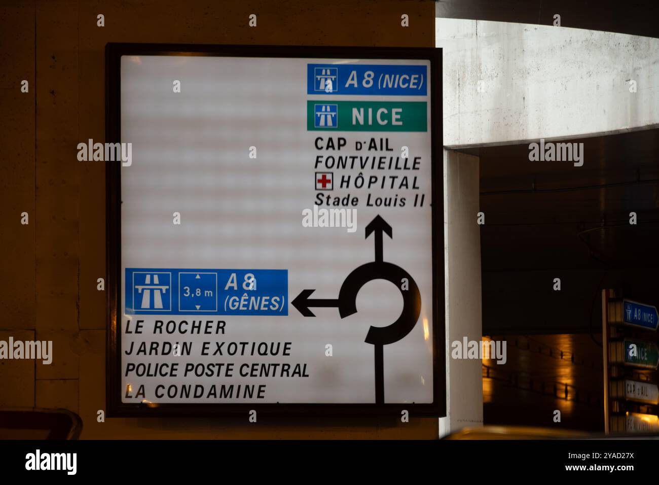 Driving car on narrow streets of Monaco, road signes with directions to ...