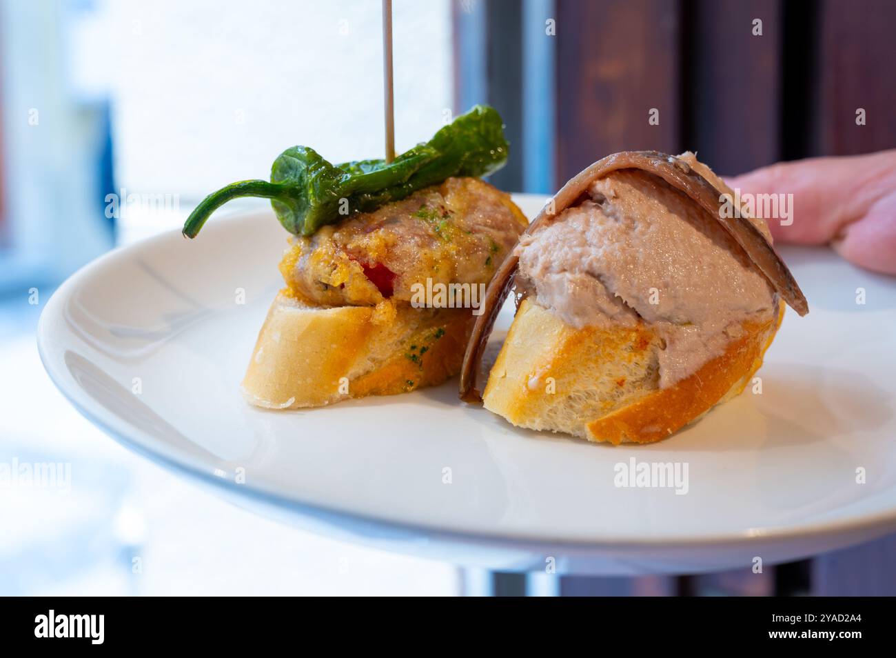 Typical snacks of Basque Country, pinchos or pinxtos skewers with small ...