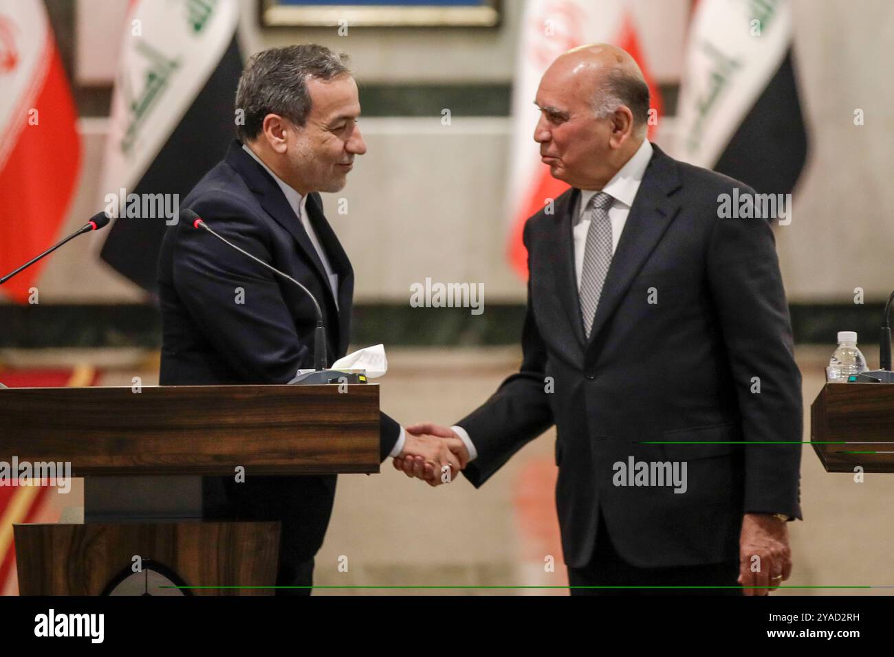 Iraqi Foreign Minister Fuad Hussein, right, shakes hands with visiting ...