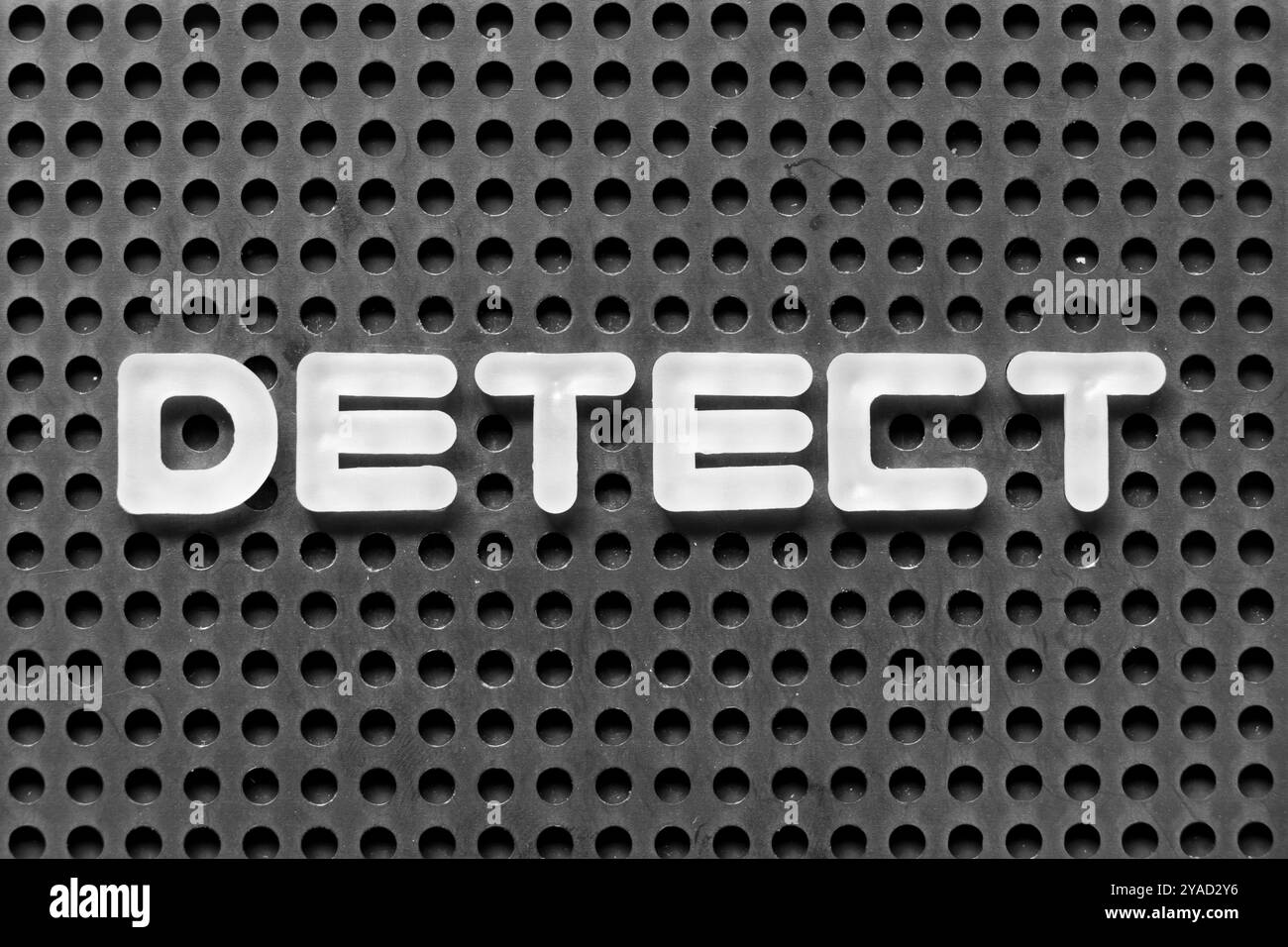 White alphabet letter in word detect on black pegboard background Stock ...