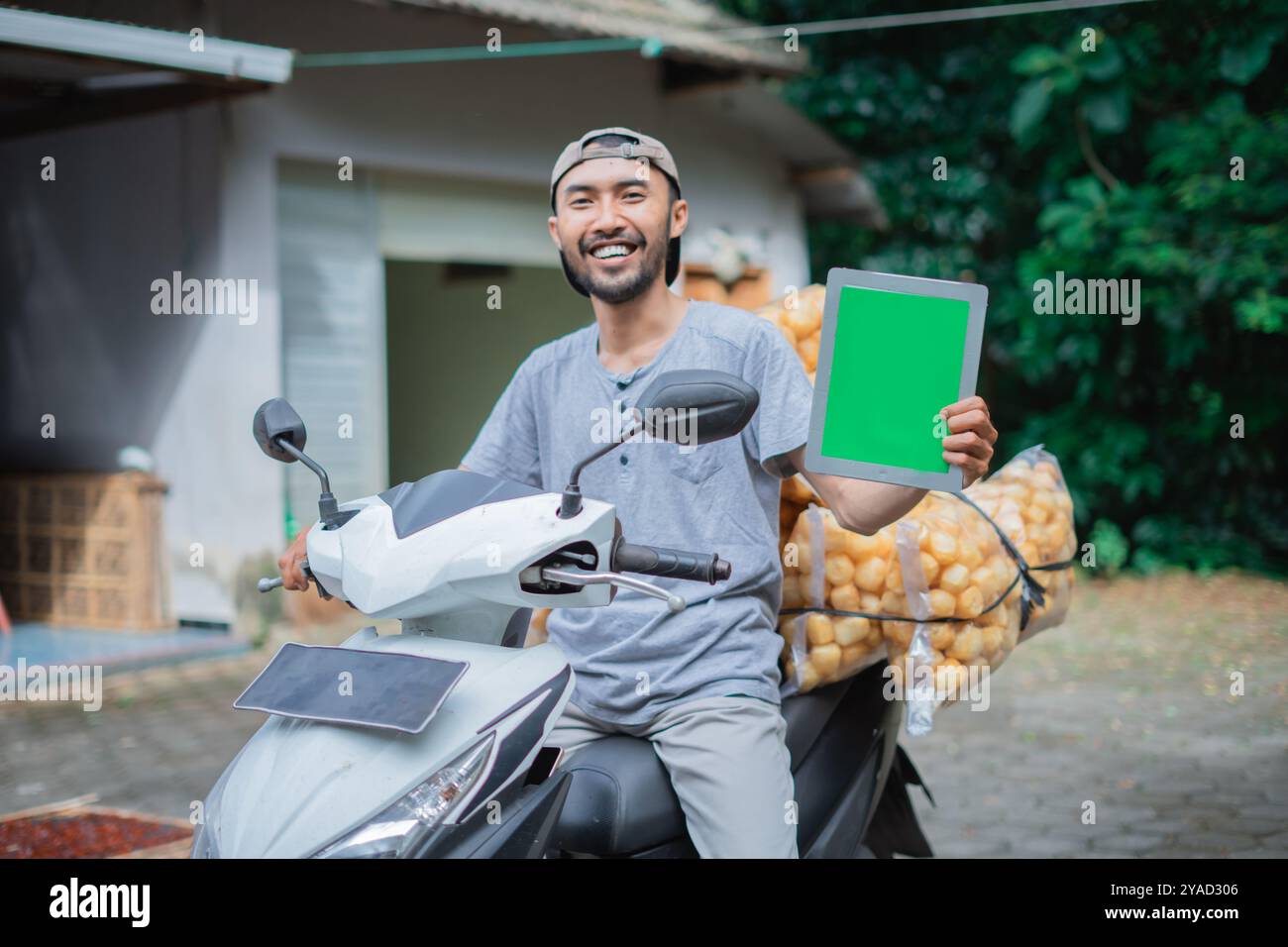 A Happy Delivery Rider Carrying Fresh Produce on His Motorcycle ...