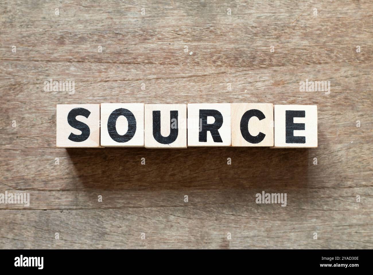 Alphabet letter block in word source on wood background Stock Photo - Alamy