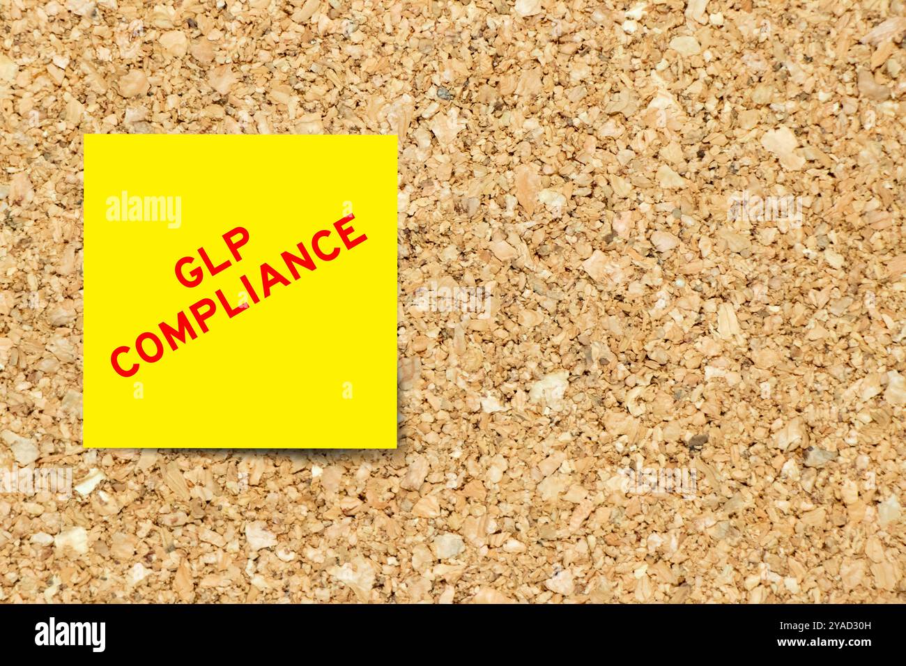 Yellow note paper with word GLP (Abbreviation of Good laboratory ...