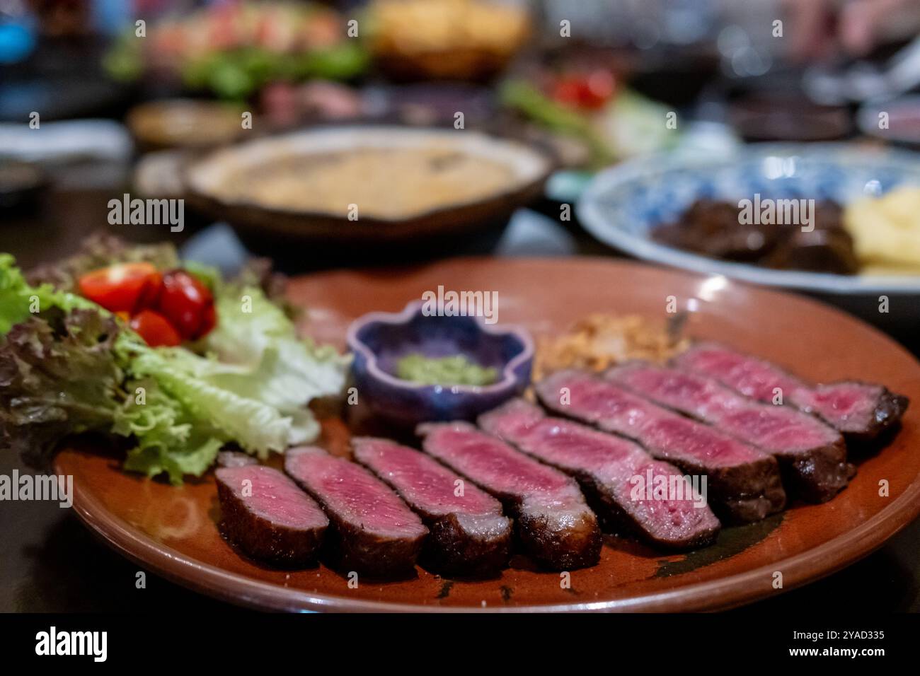 Medium rare sliced rib eye meat served on plate with vegetable Stock ...