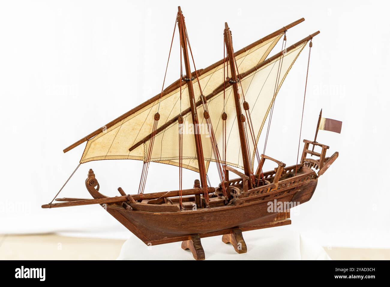 Miniature of a ancient Arabian dhow ship isolated in white background ...