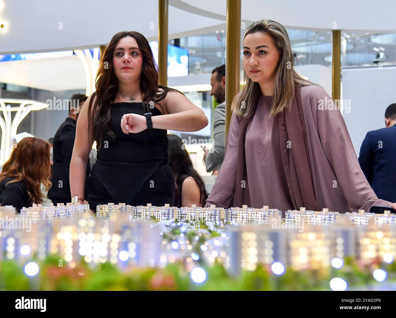 CITYSCAPE QATAR 2024Õ THE REAL ESTATE EXHIBITION IN DOHA A saleswoman ...
