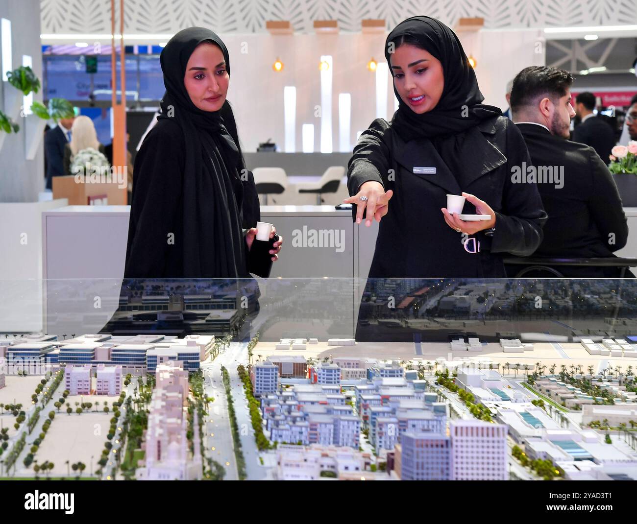 CITYSCAPE QATAR 2024Õ THE REAL ESTATE EXHIBITION IN DOHA A saleswoman ...