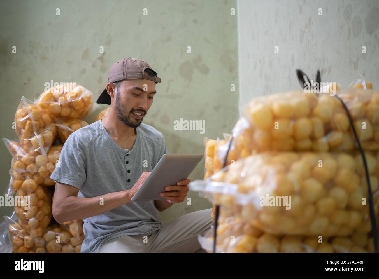 A Young Man is Effectively Managing Inventory in a Storage Area Using a ...