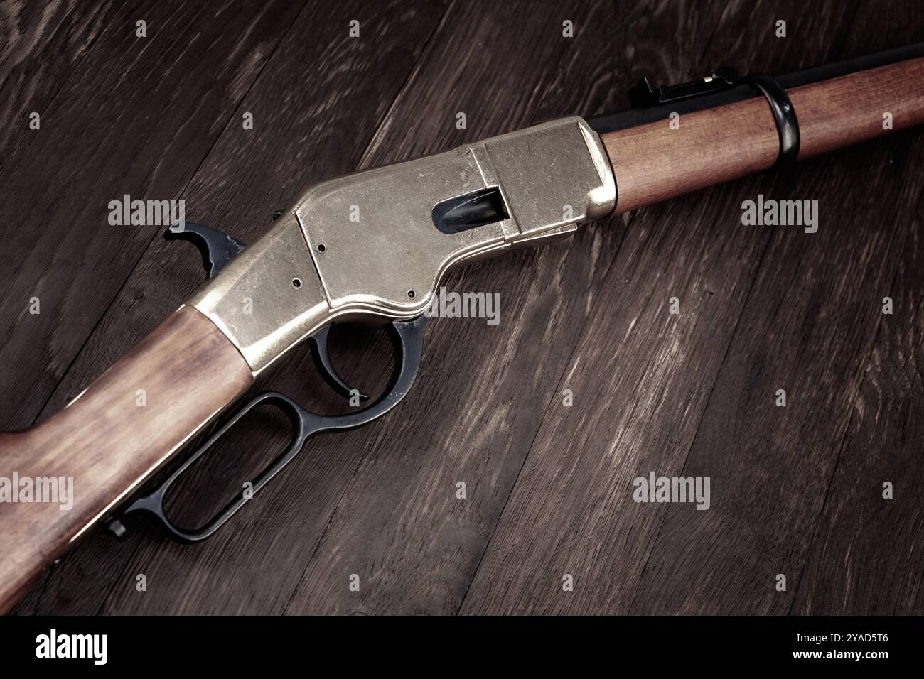 Old west lever action repeating rifle on wooden table Stock Photo - Alamy