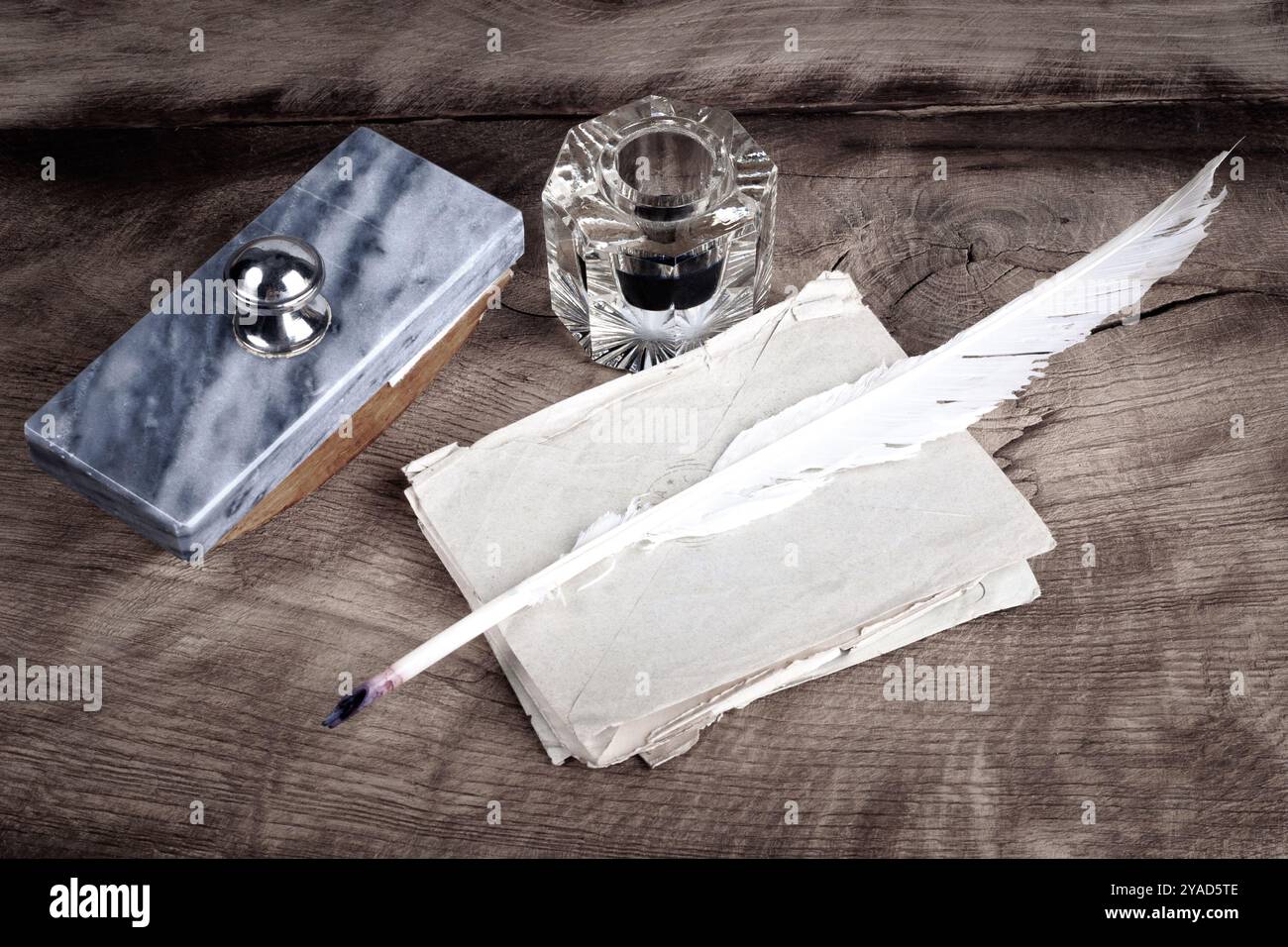 Vintage retro fountain pen and inkwell with old letters on a wooden ...