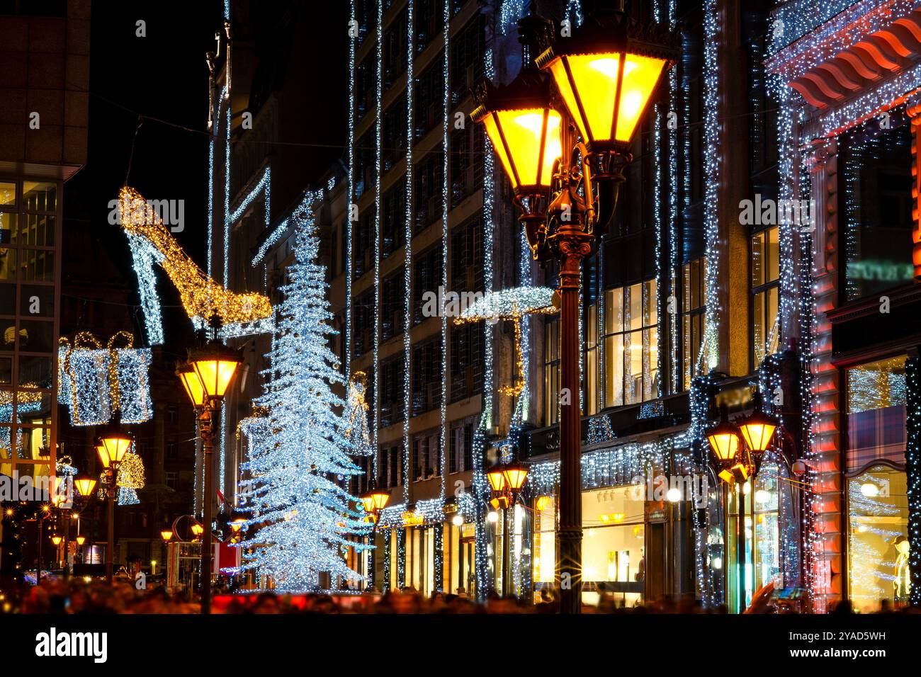 Festive Christmas lights on a busy Budapest shopping street at night ...