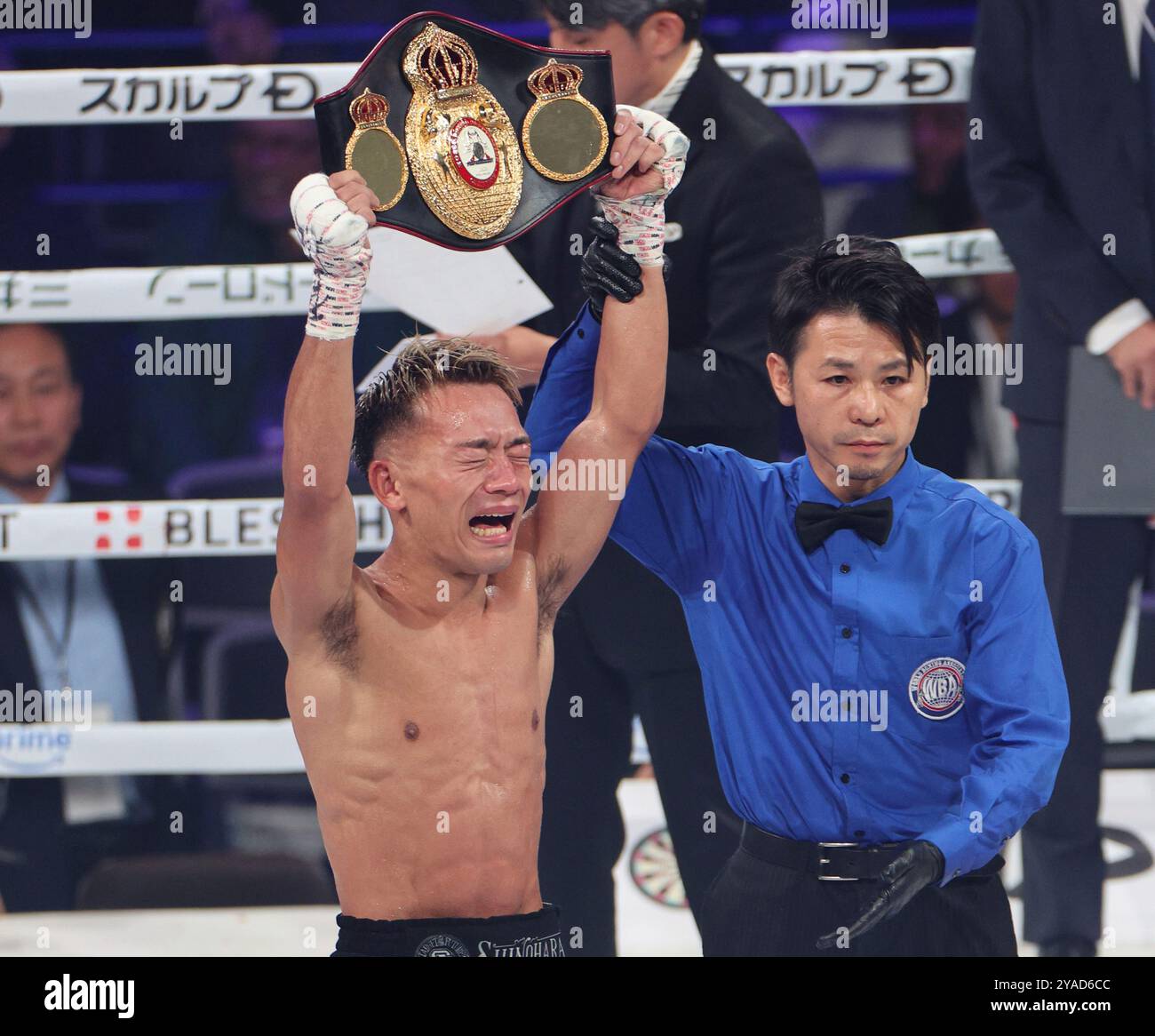 Japan's Seiya Tsutsumi raises the champion belt above his head after ...