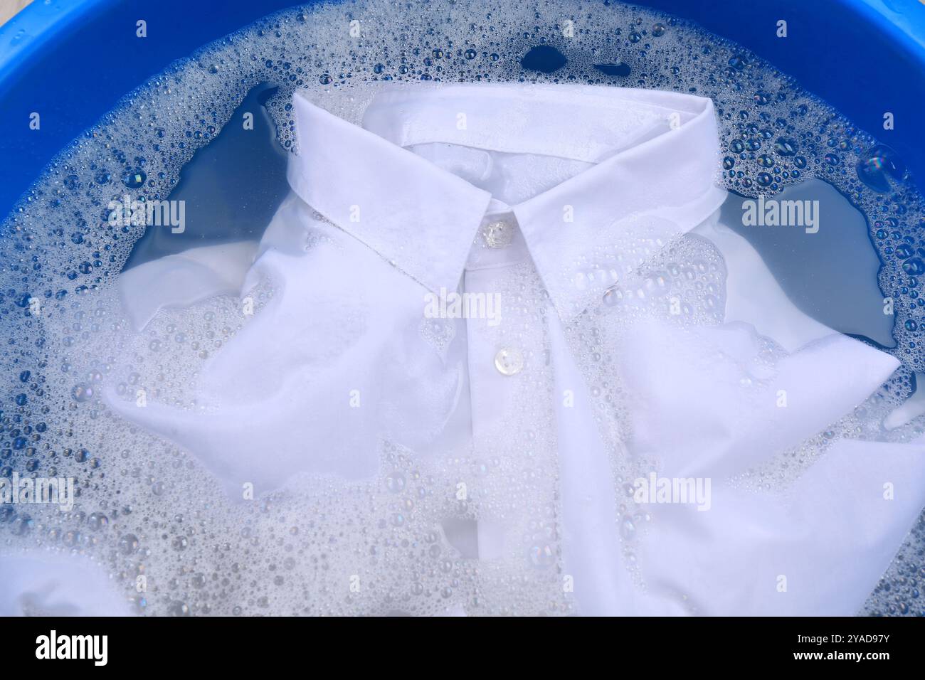 White shirt in suds, closeup. Hand washing laundry Stock Photo - Alamy
