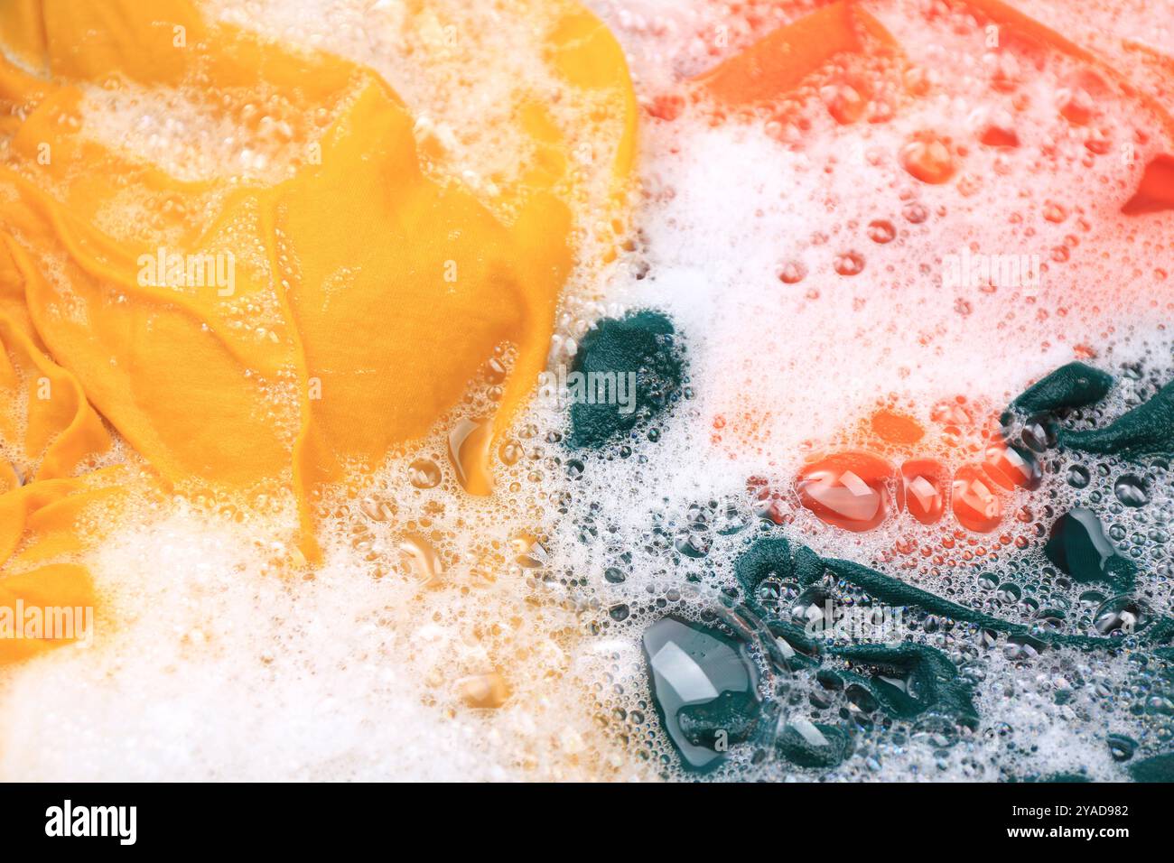 Colorful clothes in suds, closeup. Hand washing laundry Stock Photo - Alamy