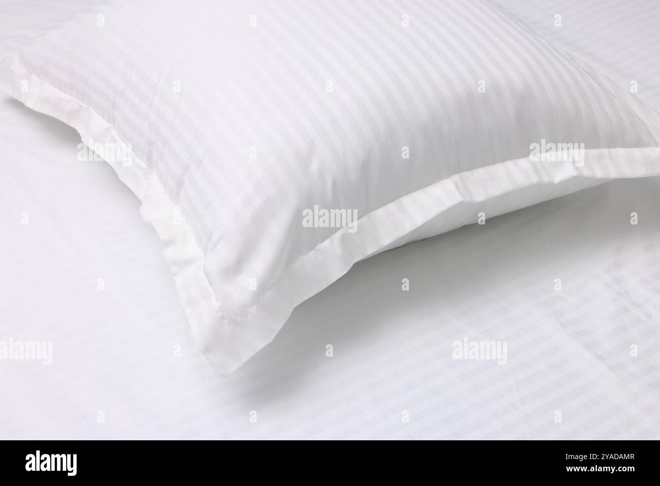 Bed with white clean linens and pillow Stock Photo - Alamy
