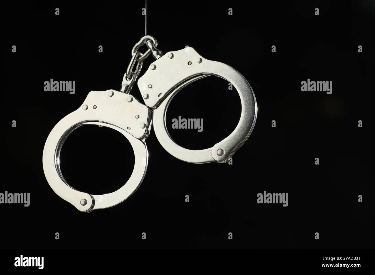 Metal chain handcuffs on black background, closeup Stock Photo - Alamy