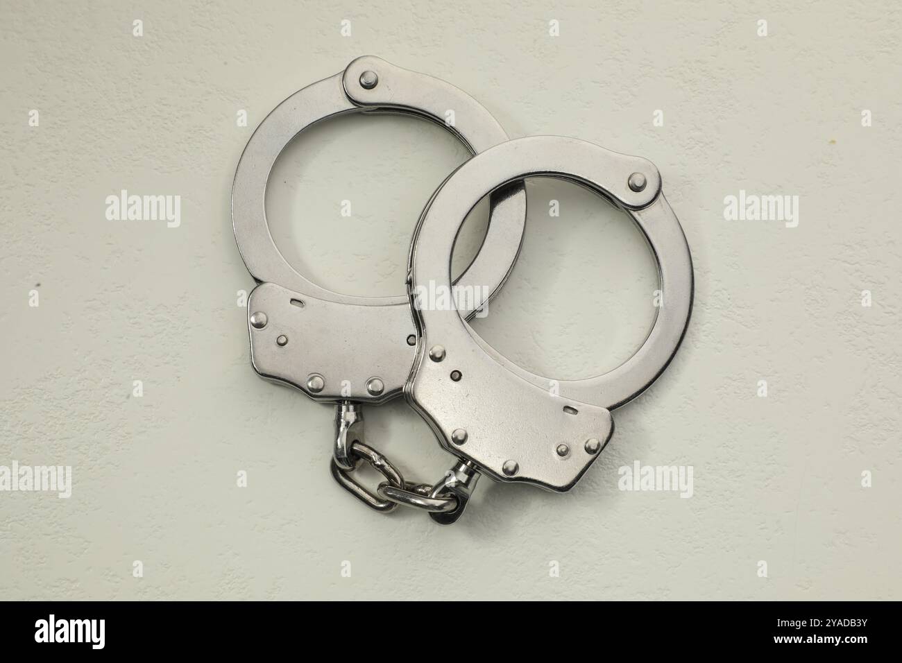 Classic chain handcuffs on white table, top view Stock Photo - Alamy