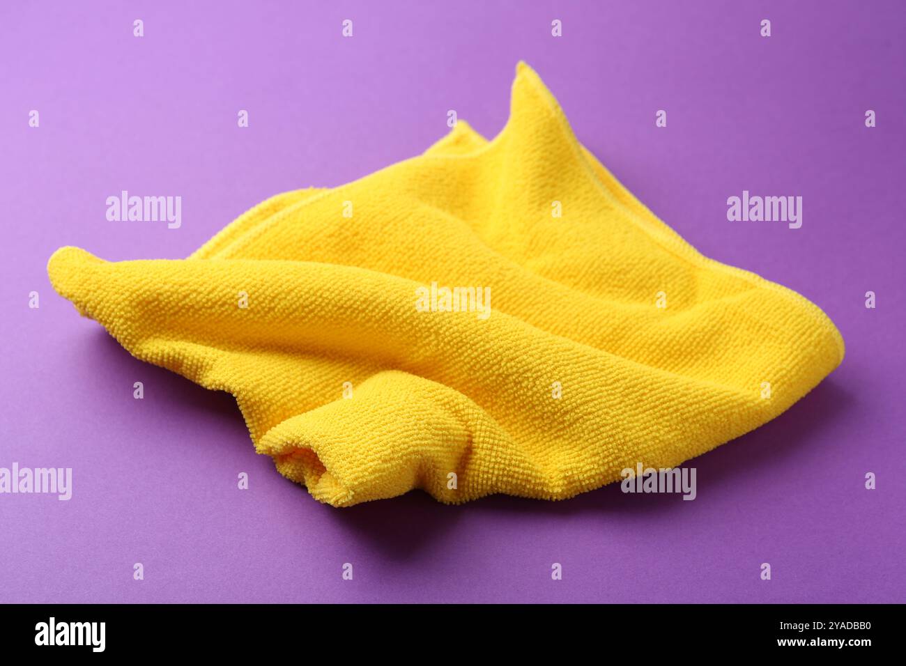 Clean yellow microfiber cloth on purple background, closeup Stock Photo ...