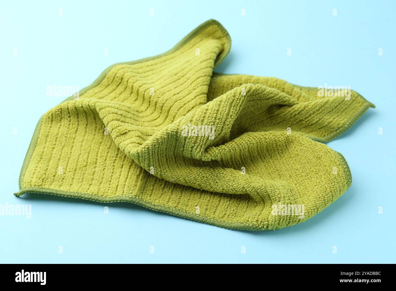 Clean green microfiber cloth on light blue background, closeup Stock ...