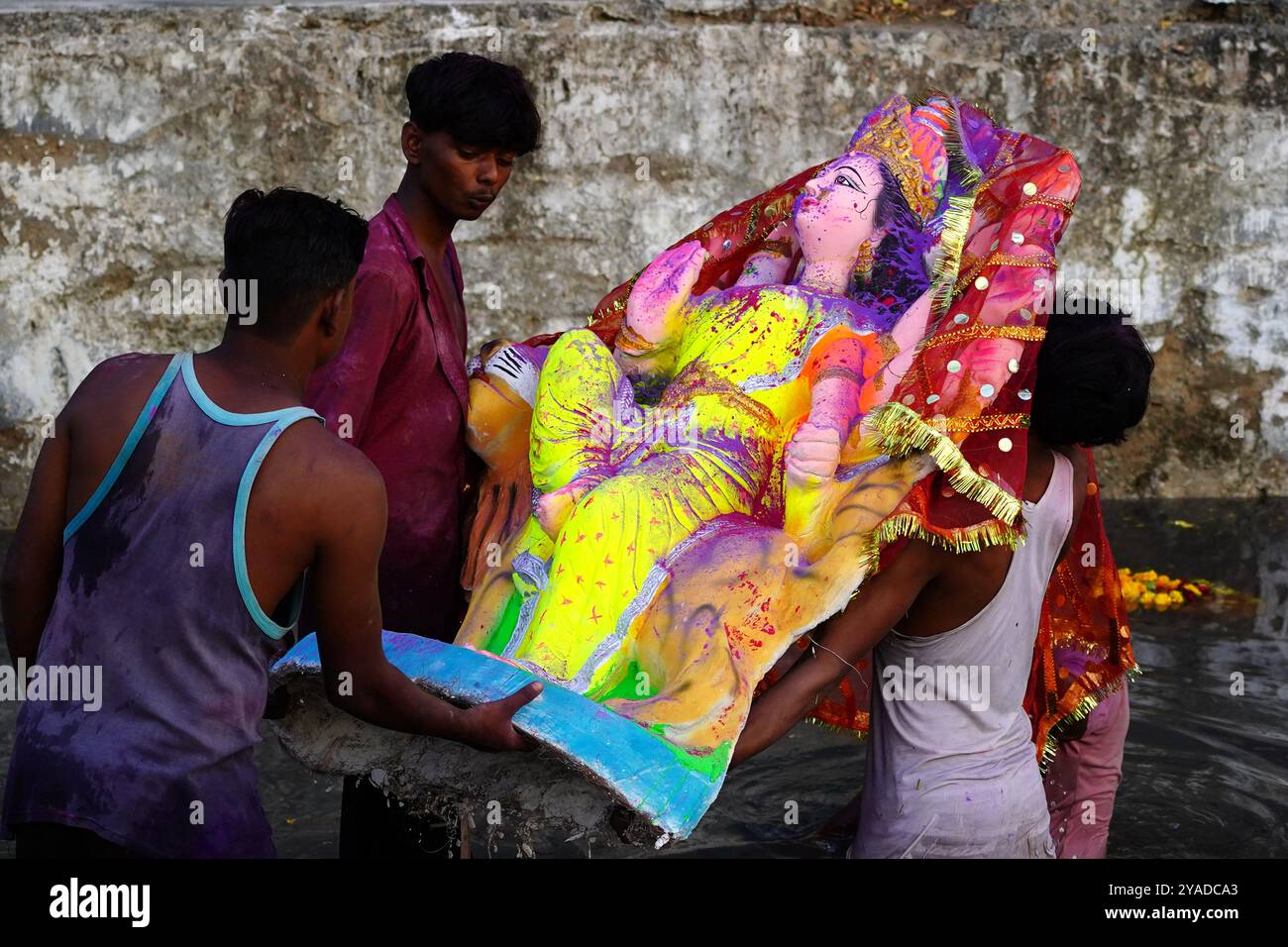 Indian Devotees immerse idols of the Hindu goddess Durga on the last day of the Durga Puja ...