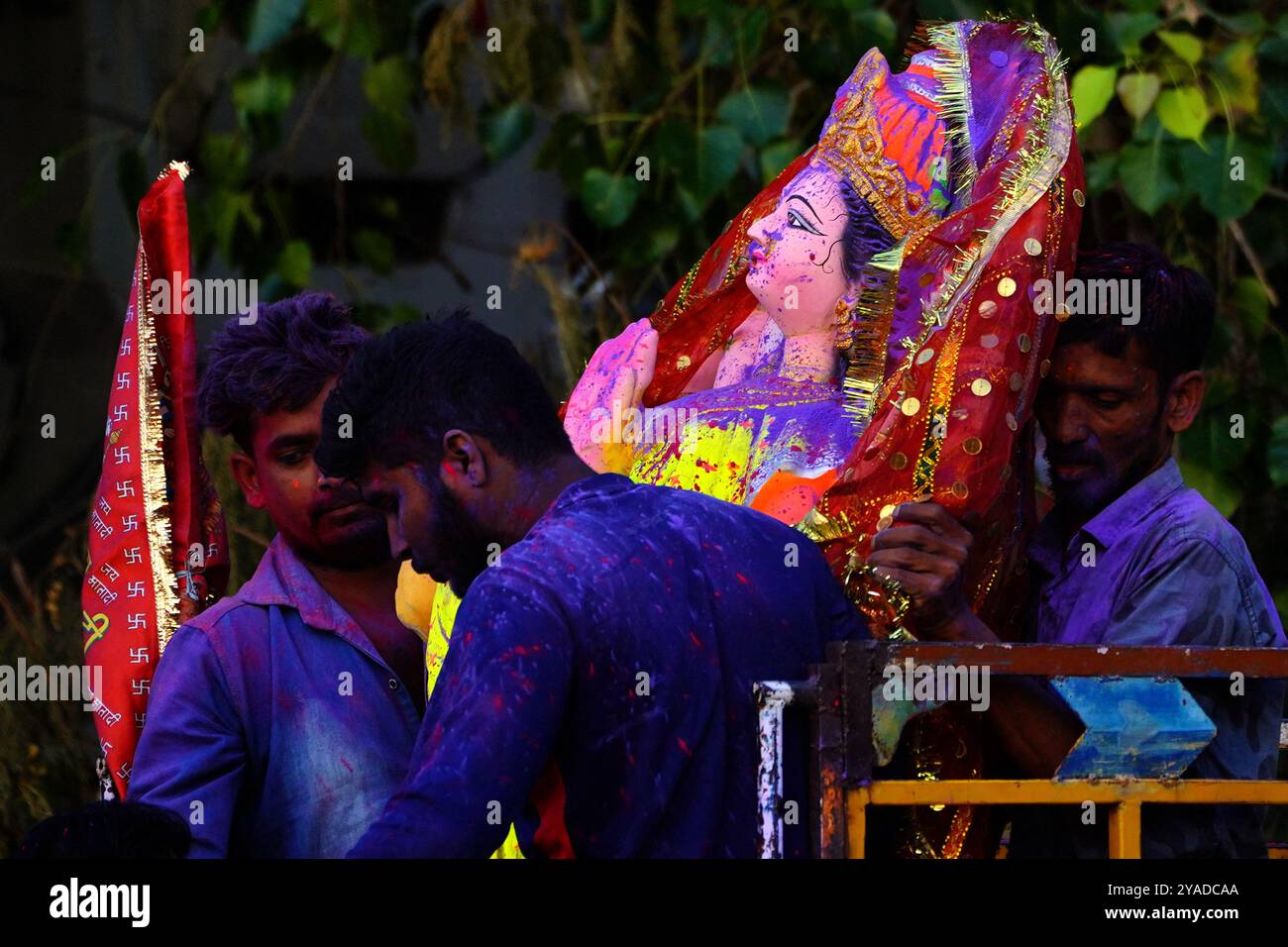 Indian Devotees immerse idols of the Hindu goddess Durga on the last day of the Durga Puja ...