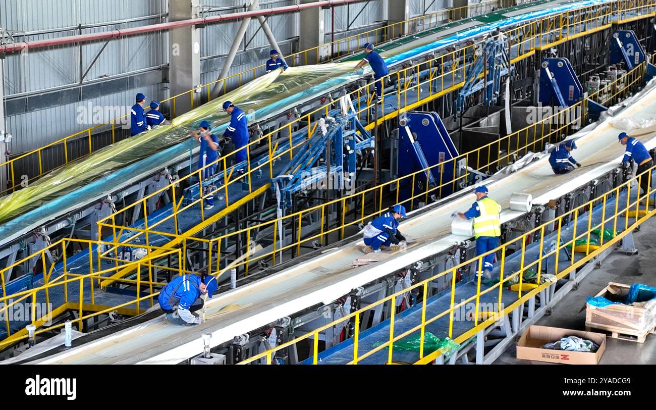 ZHANGYE, CHINA - OCTOBER 12, 2024 - Staff are producing wind turbine ...