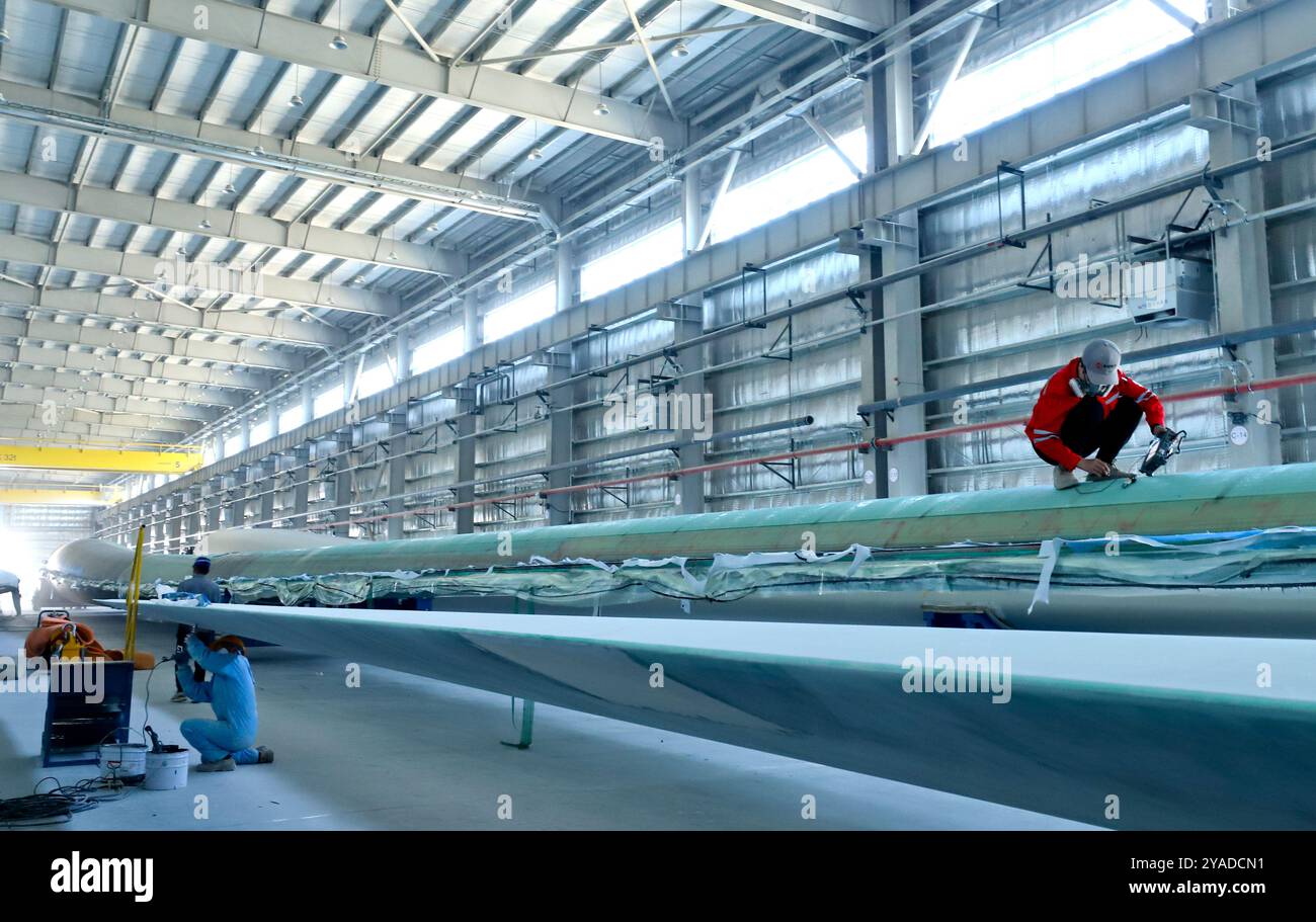 ZHANGYE, CHINA - OCTOBER 12, 2024 - Staff are producing wind turbine ...