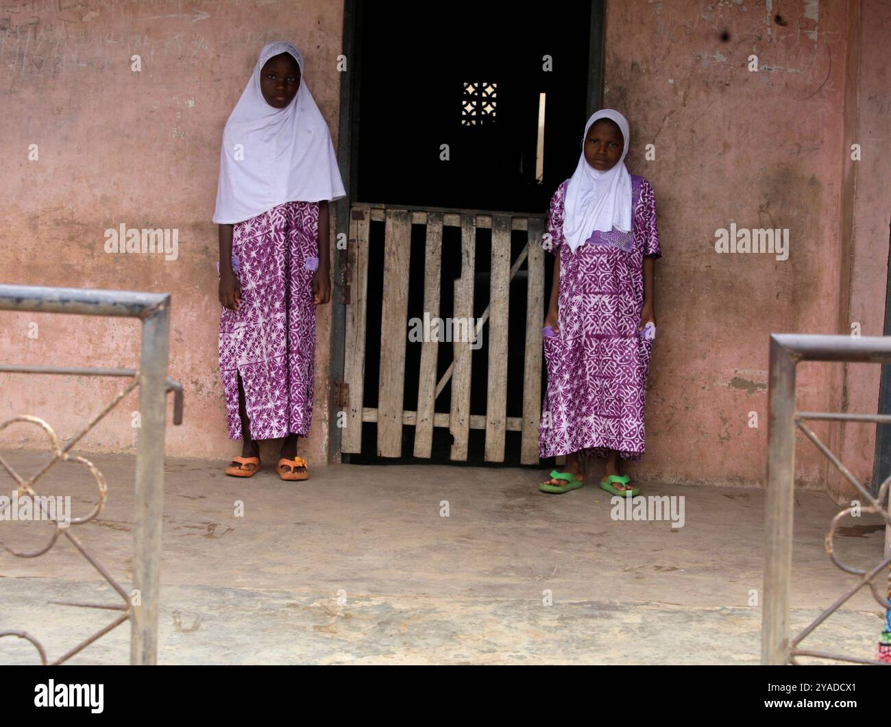 Female twins stand in front of their house during the 2024 edition of ...