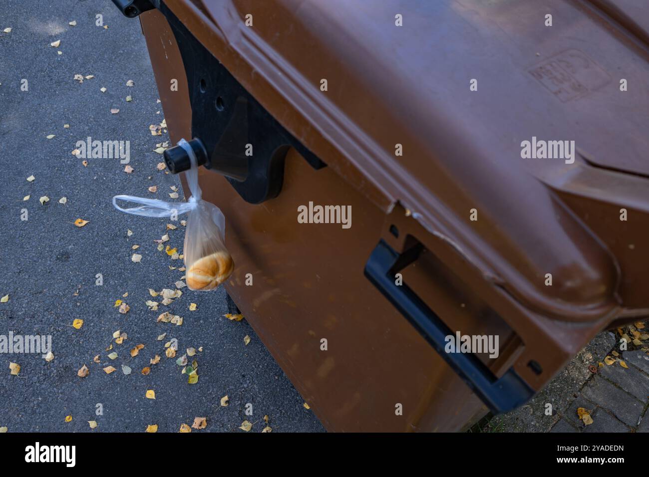 Stale bread in a plastic bag thrown into the trash, food in the trash ...