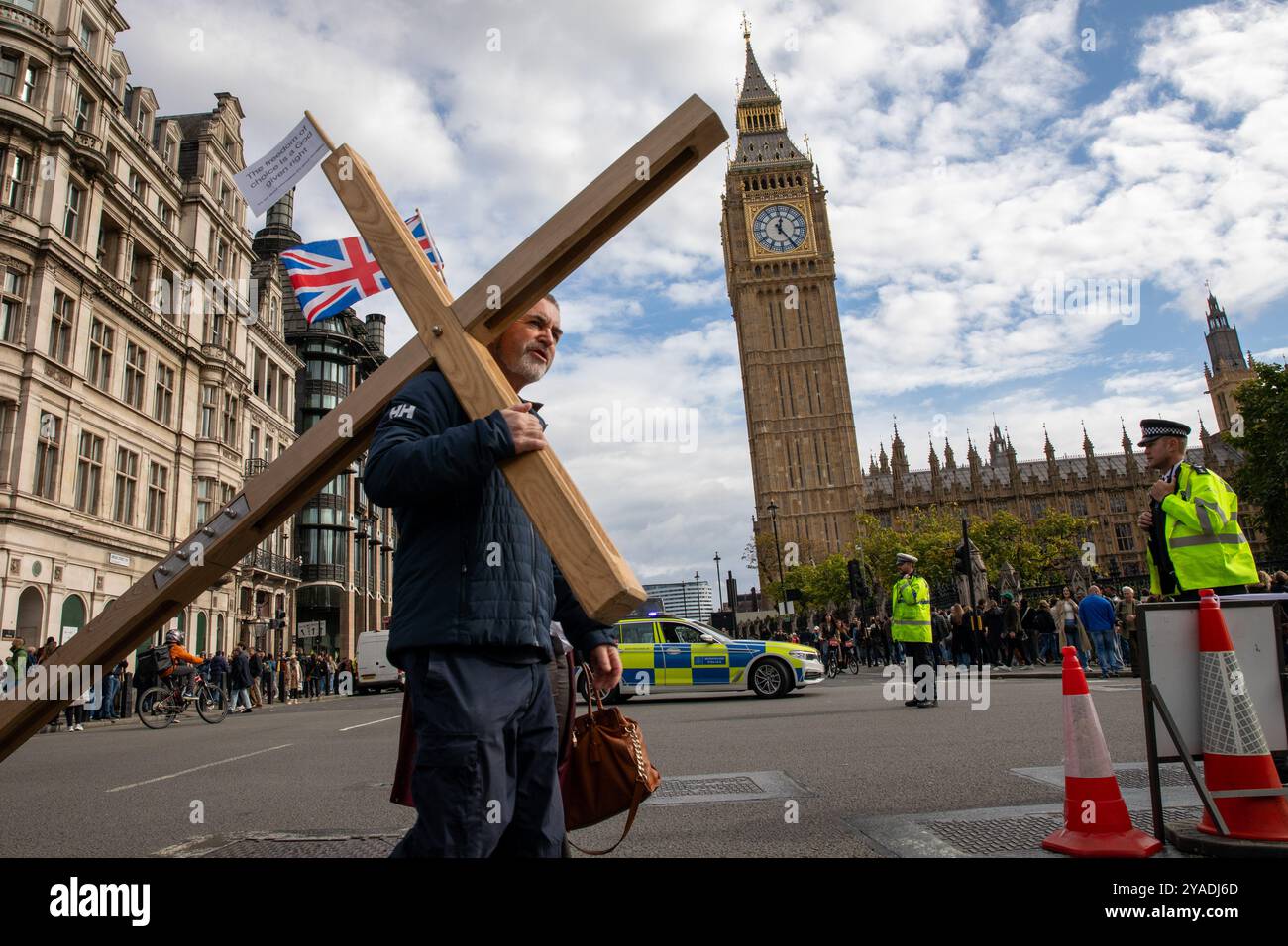 A disciple of Christ carries a cross in-front of Big Ben during the ...