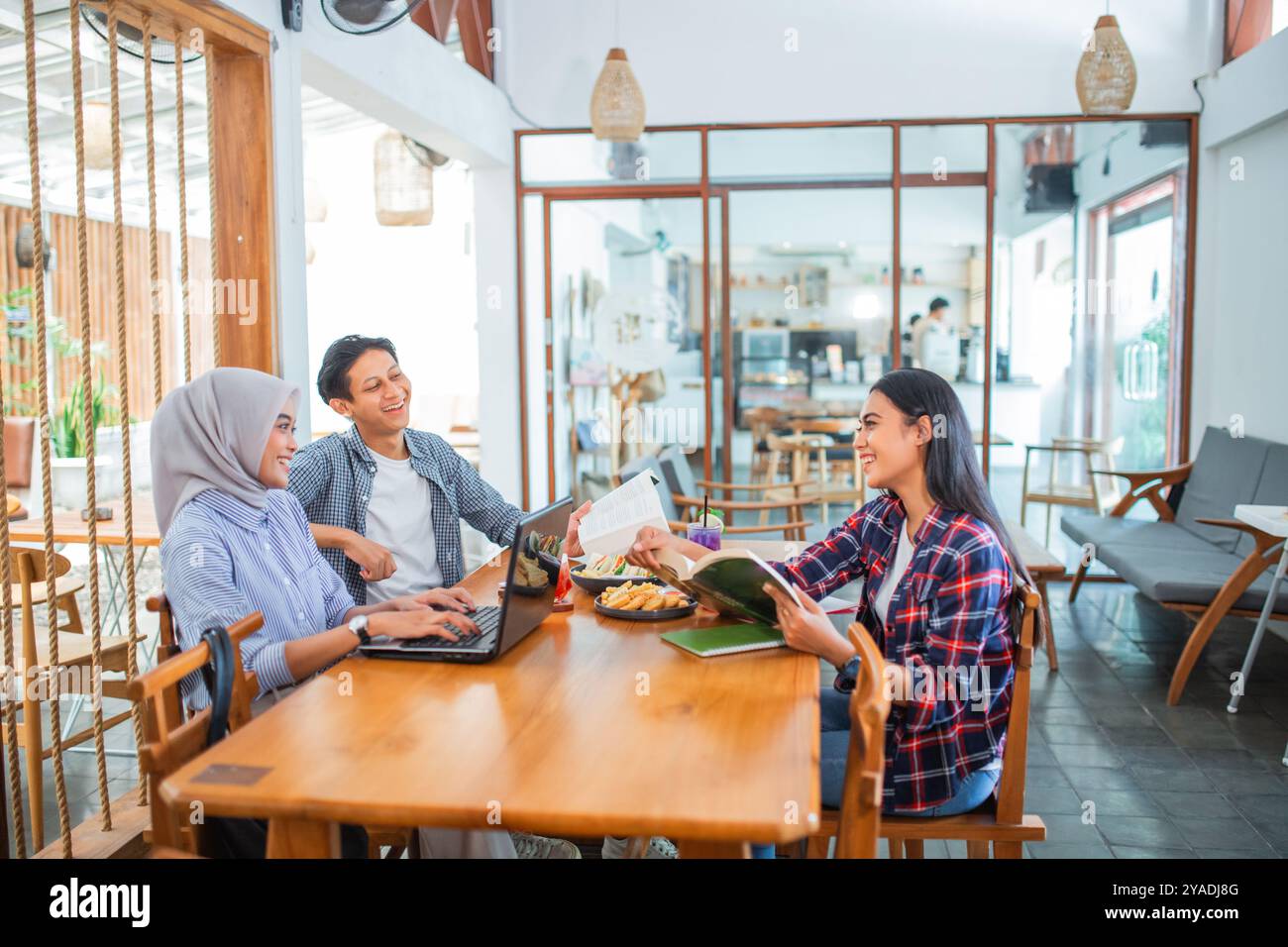 male and female university students group study together at a coffee ...
