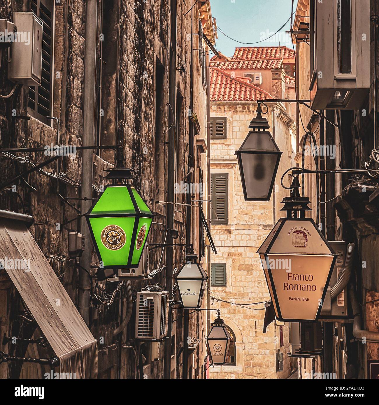 Advertising lamps hanging outside bars and shops in the old town of ...