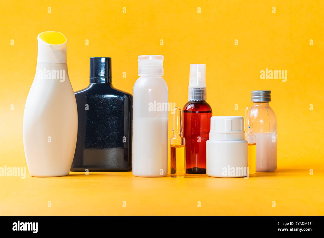 A collection of various cosmetic and pharmaceutical bottles arranged on ...