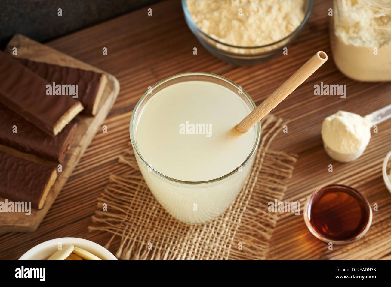 Fresh whey protein drink in a glass cup with an ecological bamboo straw ...