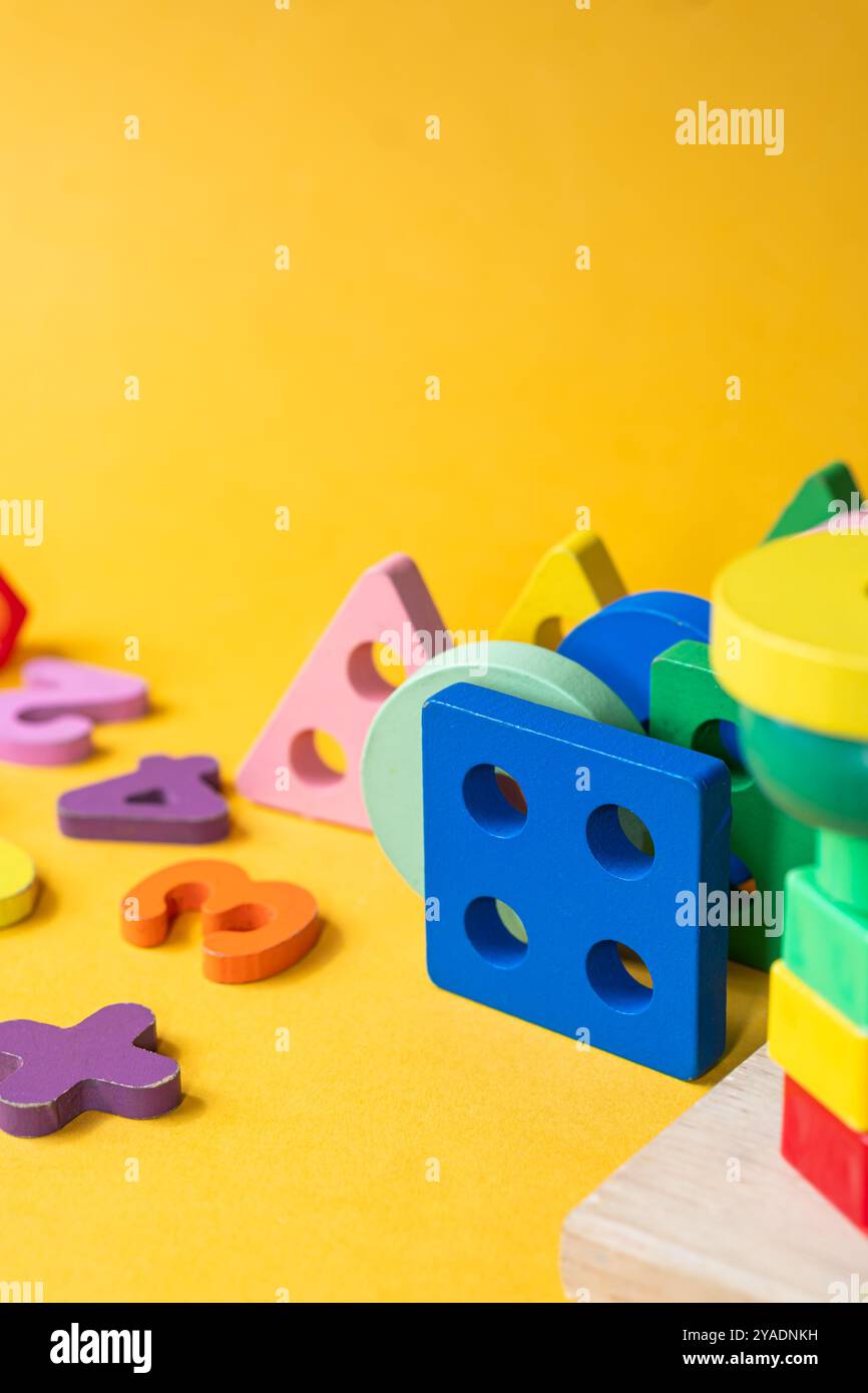 A colorful arrangement of wooden educational toys including geometric ...