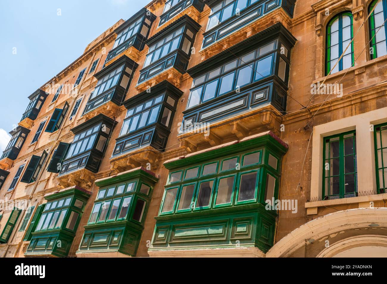 Upward view of the traditional Maltese buildings with balconies in ...