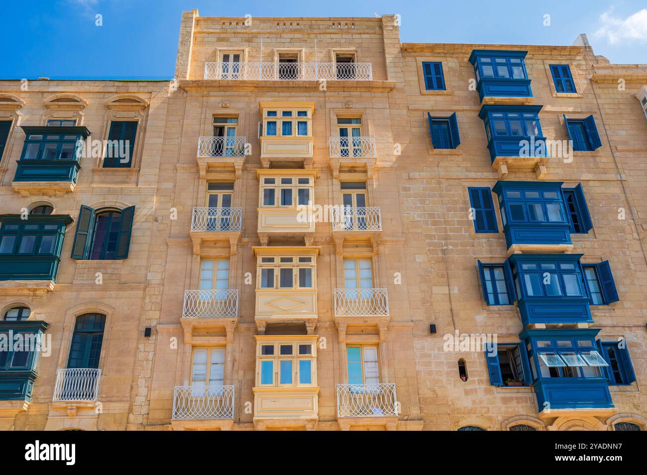 Upward view of the traditional Maltese buildings with balconies in ...