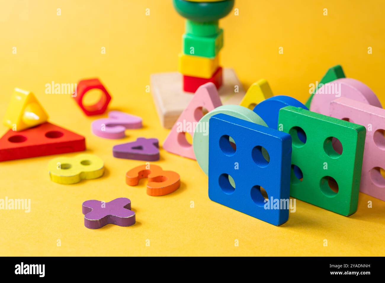 A colorful assortment of wooden geometric shapes and numbers on a ...
