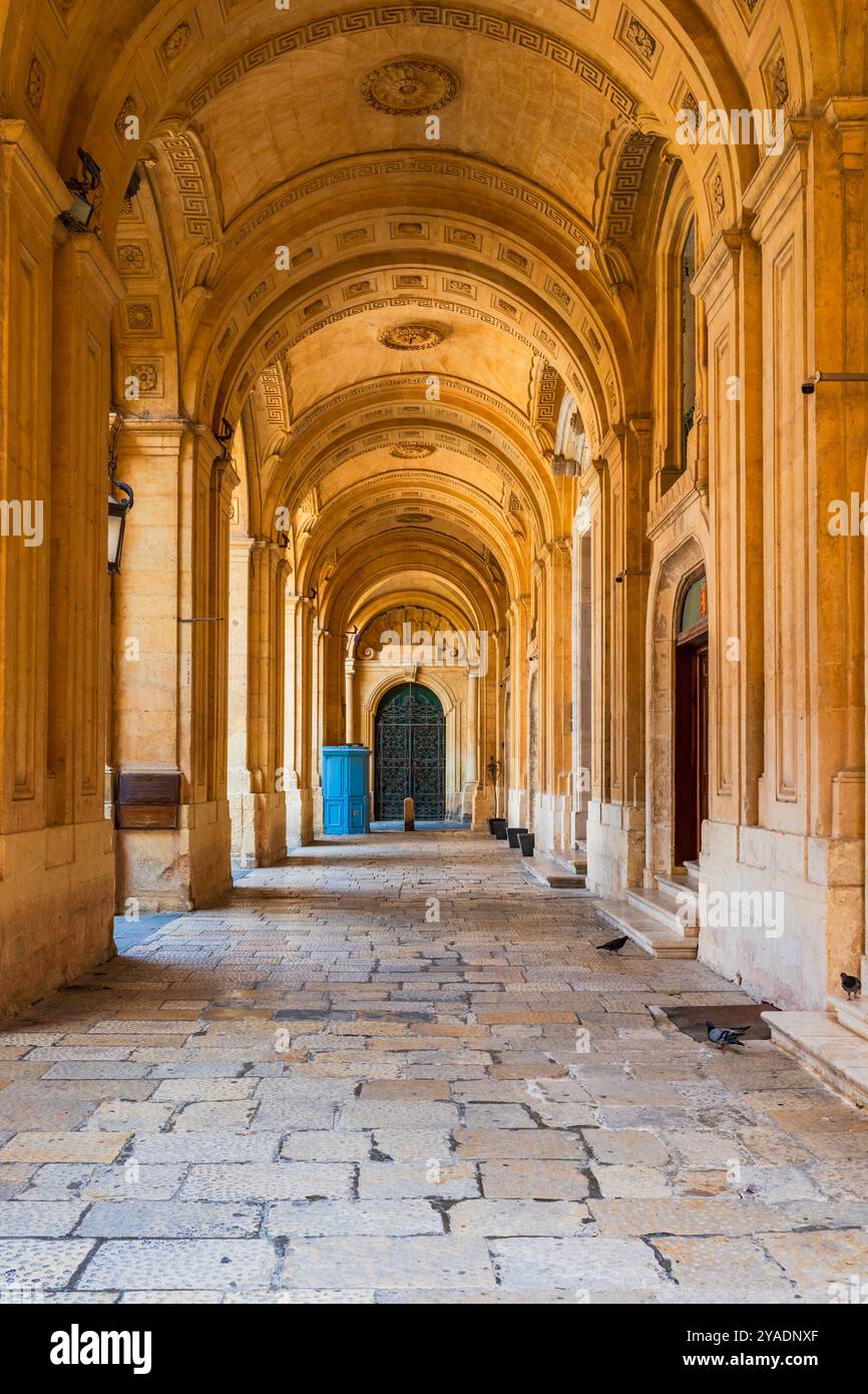 Limestone arcade of the National Library in Valletta Stock Photo - Alamy