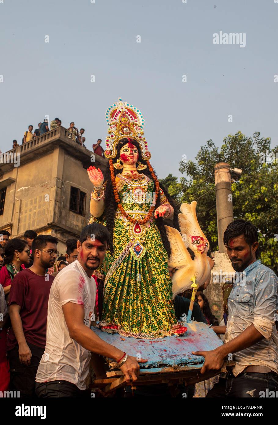 Hindu devotees carry an idol of the goddess Durga during the final day ...