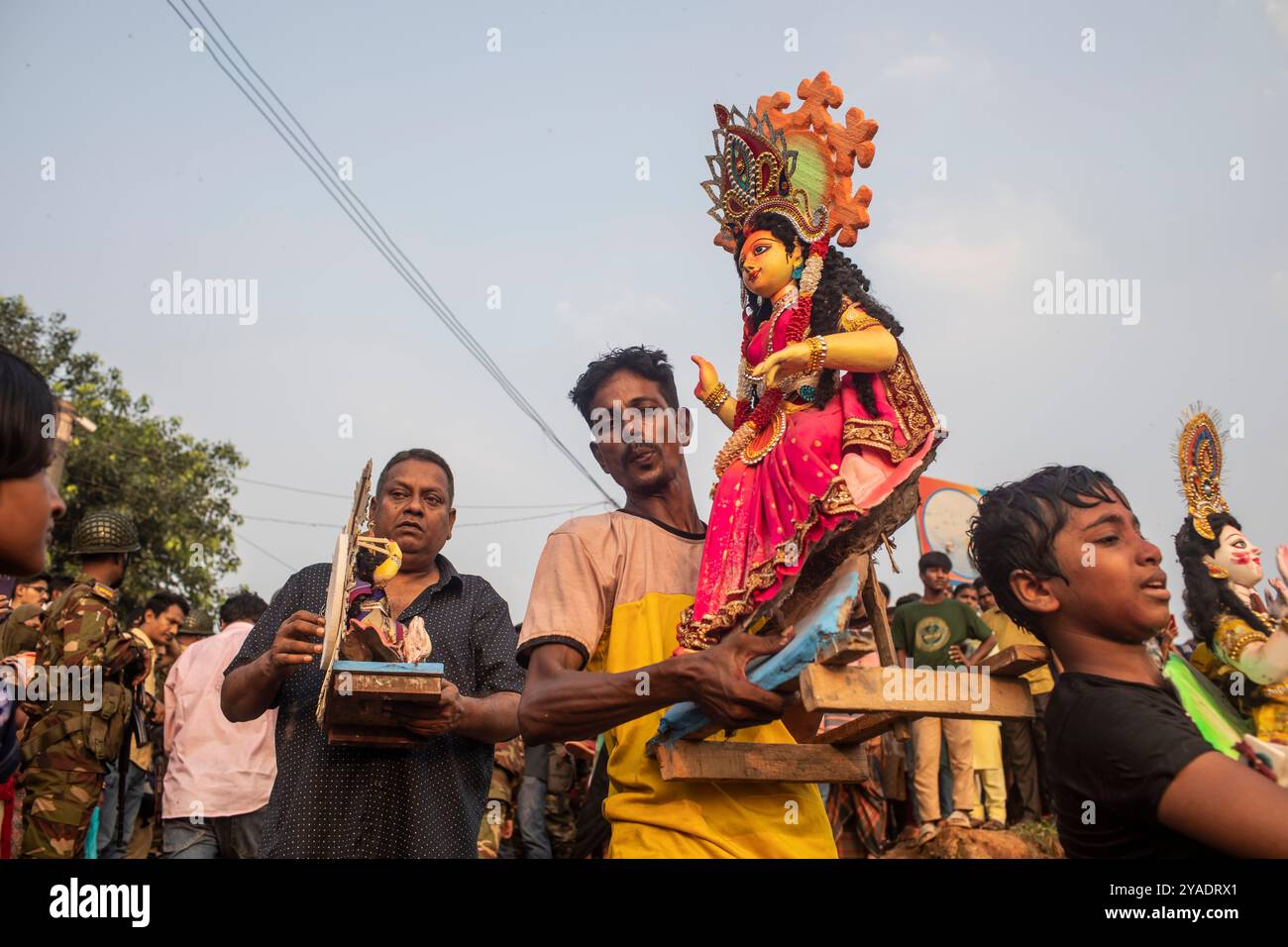 Hindu devotees carry idols of the goddess Durga during the final day of ...