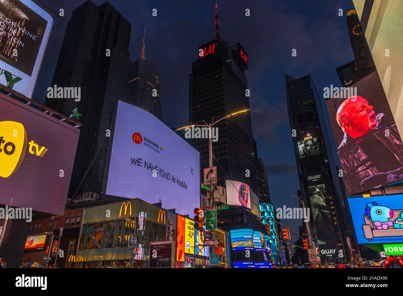 Times Square at night with towering billboards, including McDonald's ...